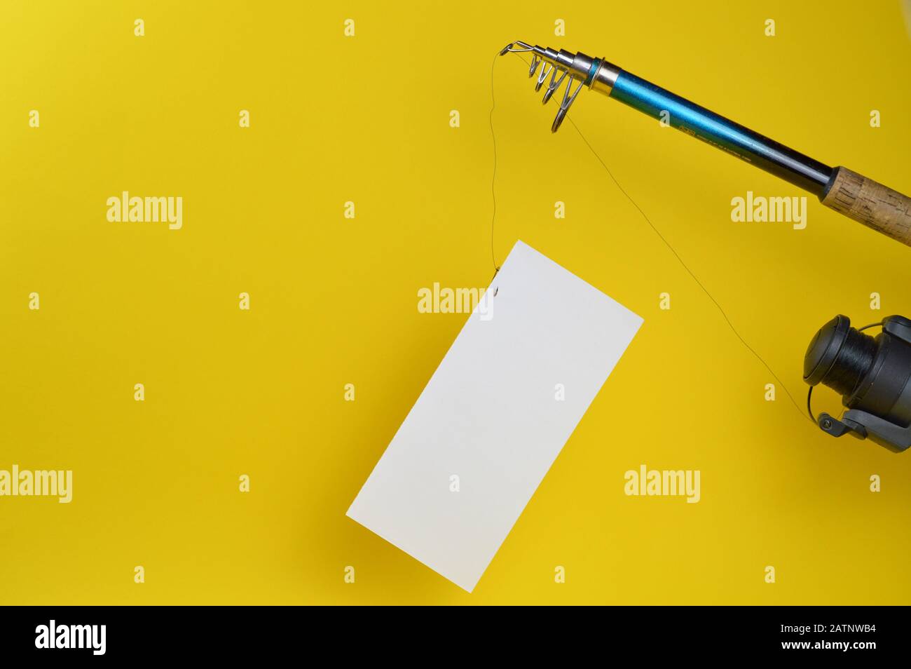 fishing line with piece of paper hanging of as symbol for temptation in ...
