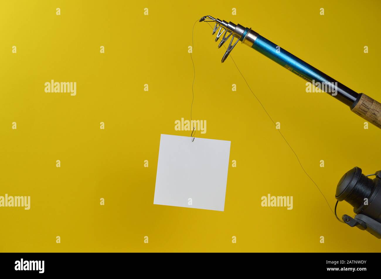 fishing line with piece of paper hanging of as symbol for temptation in ...