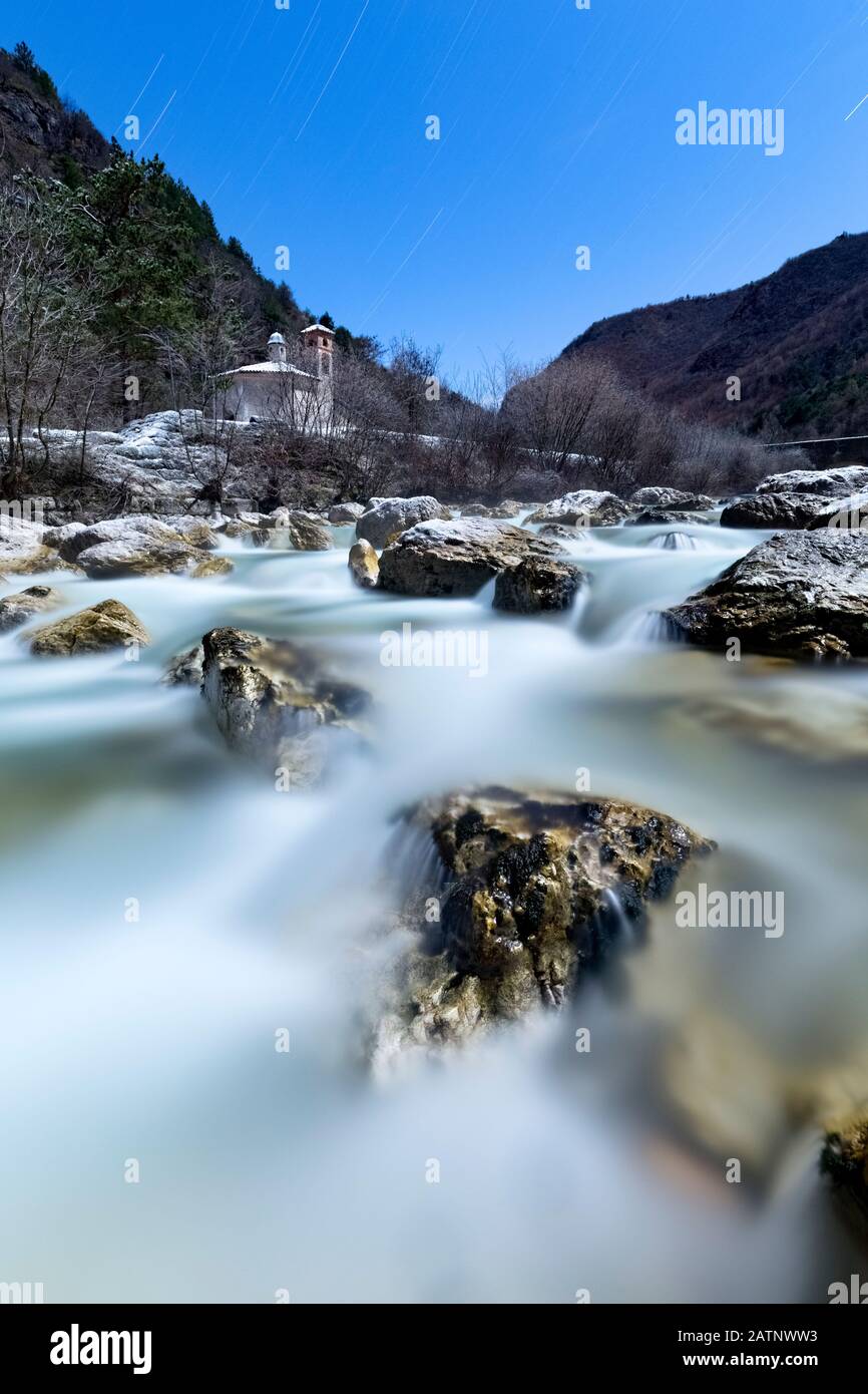 Moonlight on the stream Leno and the Sant'Antonio church. Trambileno ...
