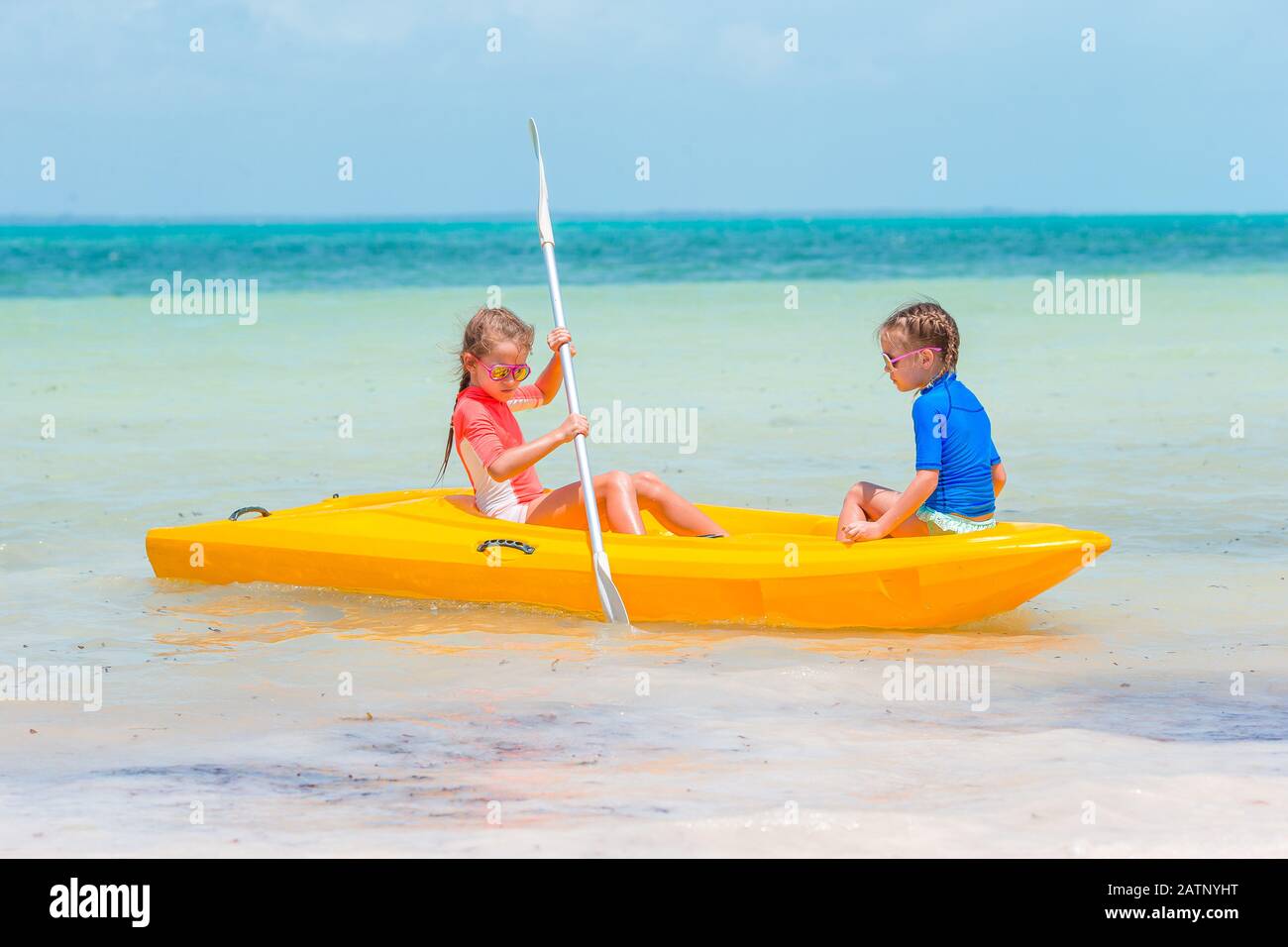 Little active girls kayaking in the ocean Stock Photo - Alamy