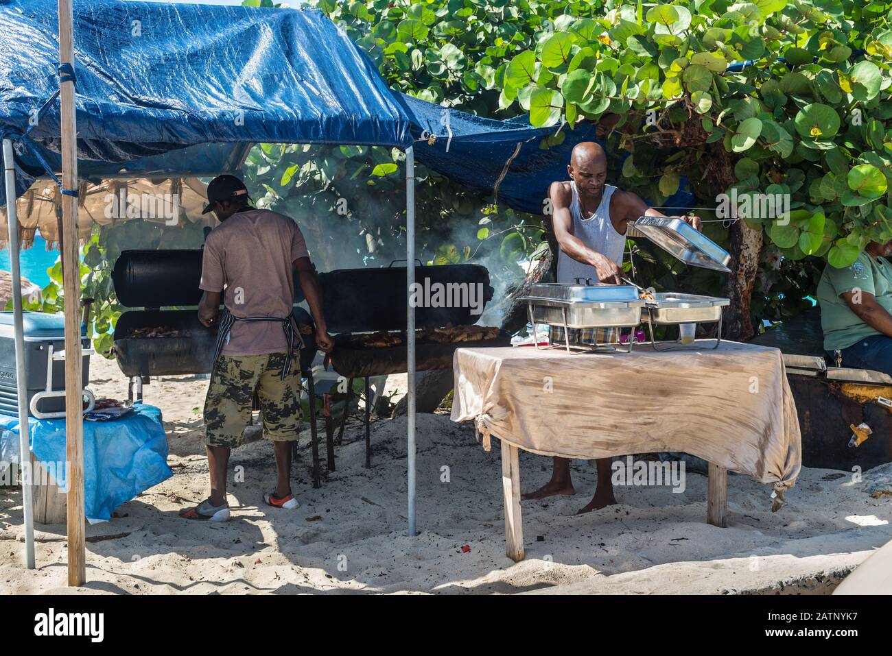 Mullet Bay, Saint Martin - December 17, 2018: Men cook hot BBQ food ...