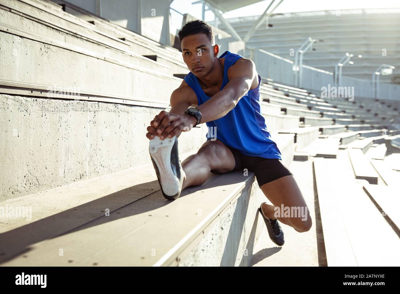 Athlete stretching at the stadium Stock Photo - Alamy
