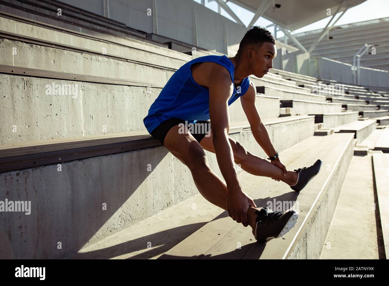 Athlete stretching at the stadium Stock Photo - Alamy