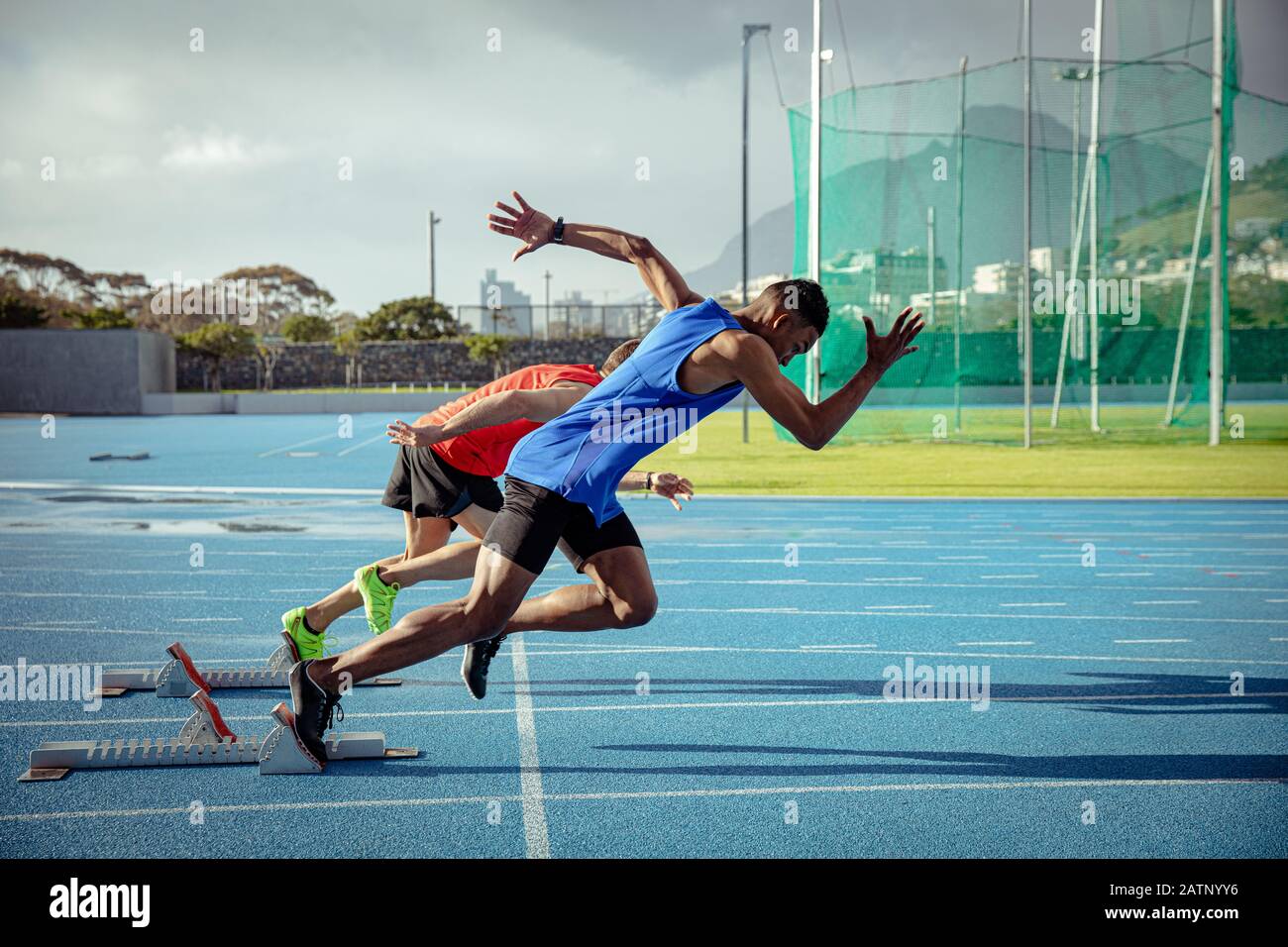 Athletes running at the stadium Stock Photo - Alamy