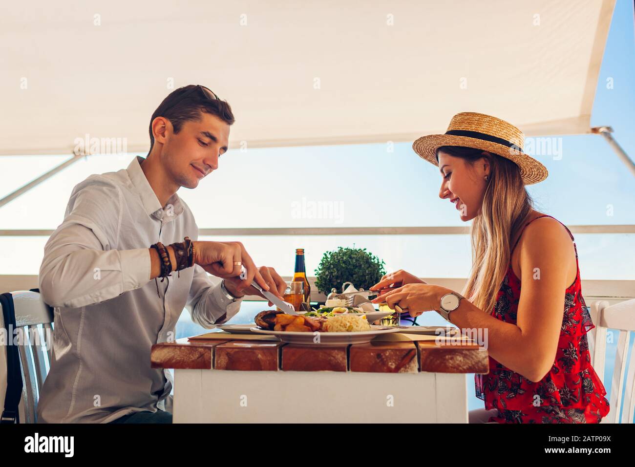 Romantic honeymoon dinner for two. Couple eating food and having drinks ...