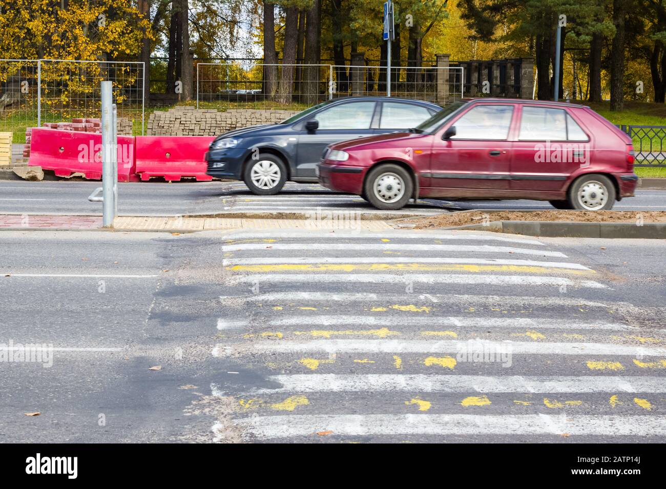 Construction work on the road close up and two cars Stock Photo - Alamy