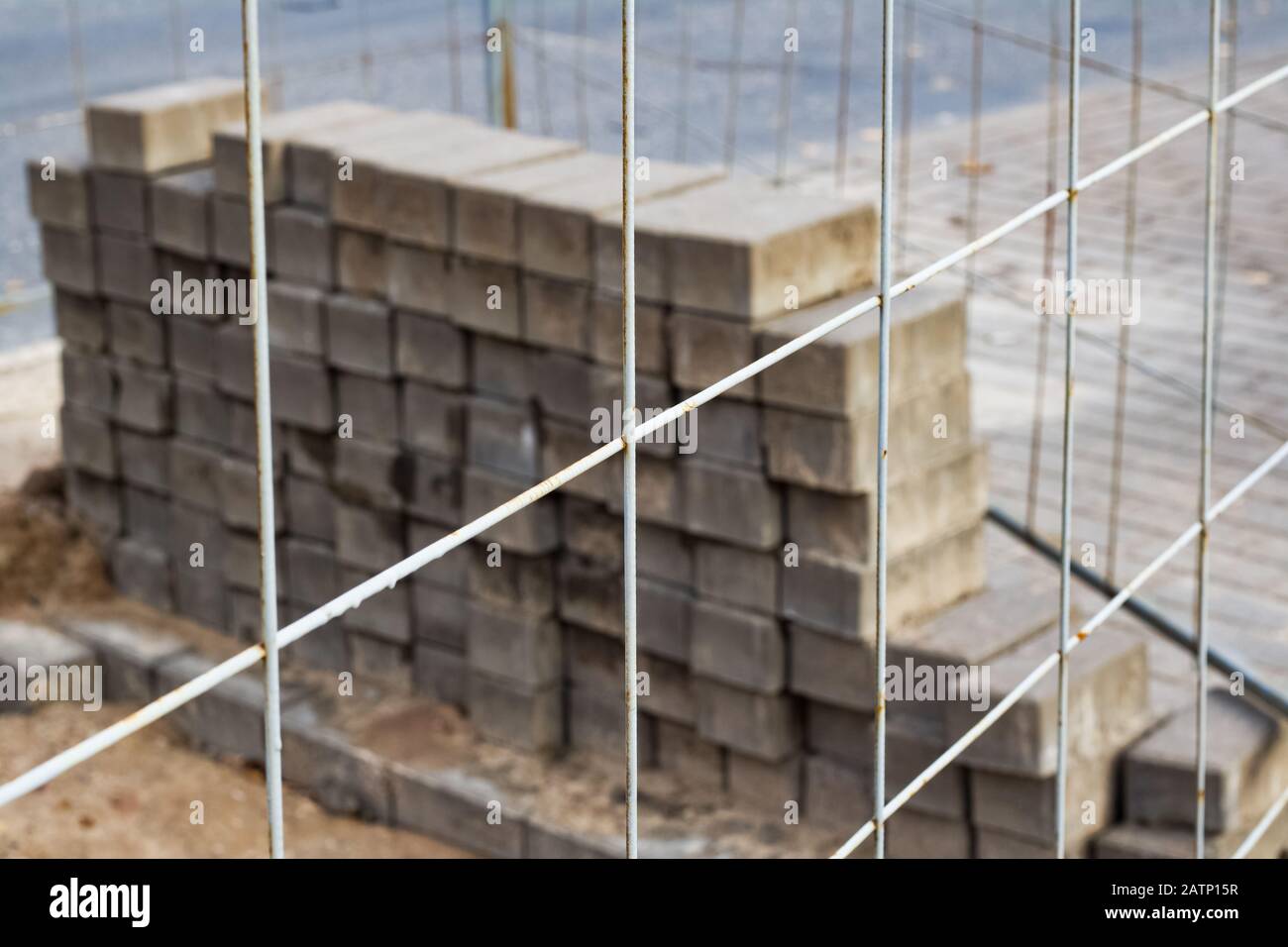 Stack of bricks at a construction site closeup behind bars Stock Photo ...