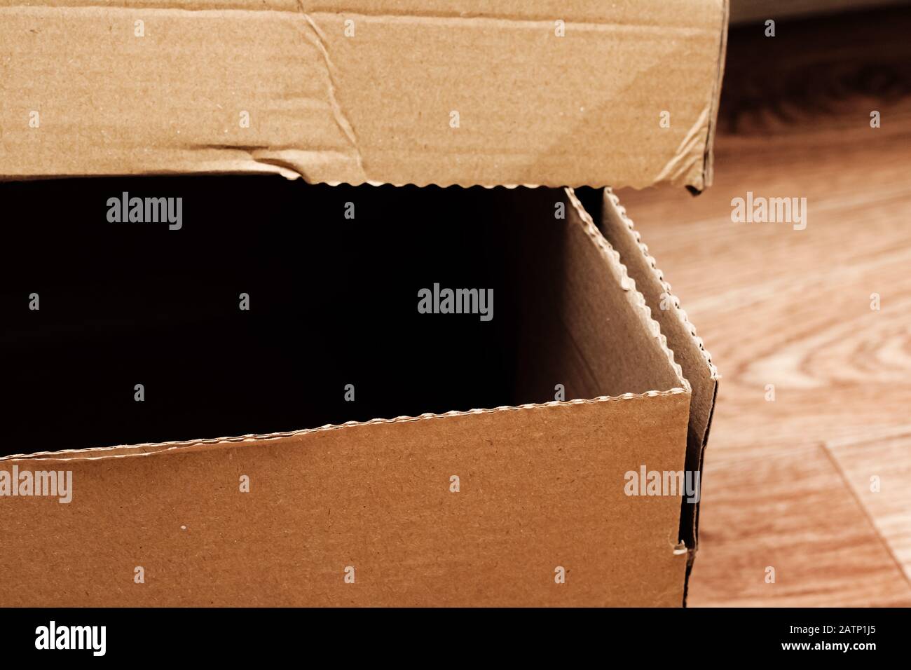 Darkness inside a cardboard box close up on wooden floor Stock Photo ...