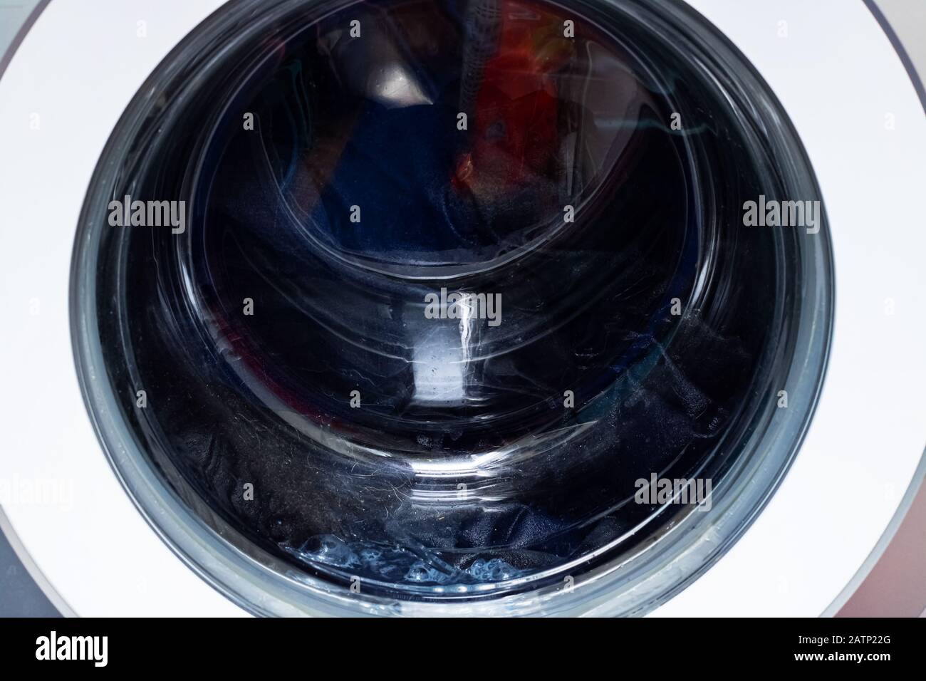 Dark laundry washing in machine drum close up, background Stock Photo ...