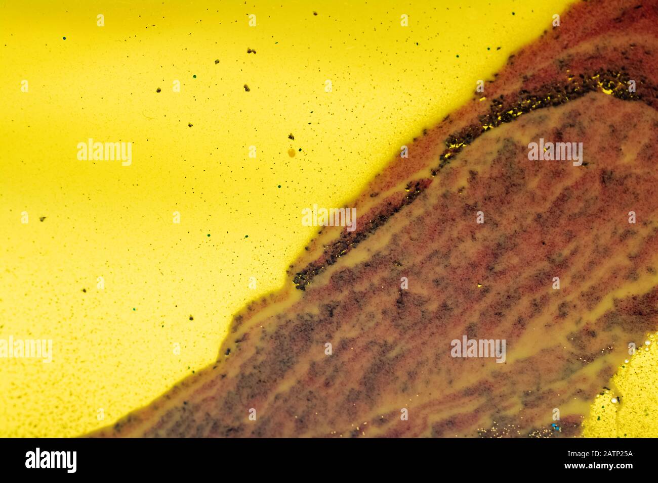 Red shiny sand in yellow water, background or texture Stock Photo - Alamy