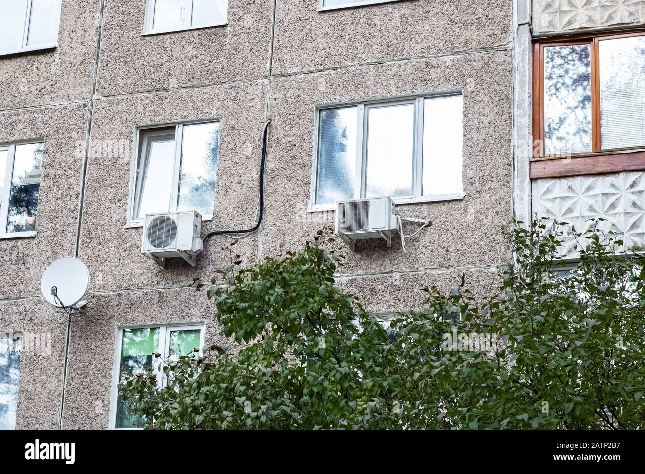Air conditioning and antenna on the windows of a tall house Stock Photo ...