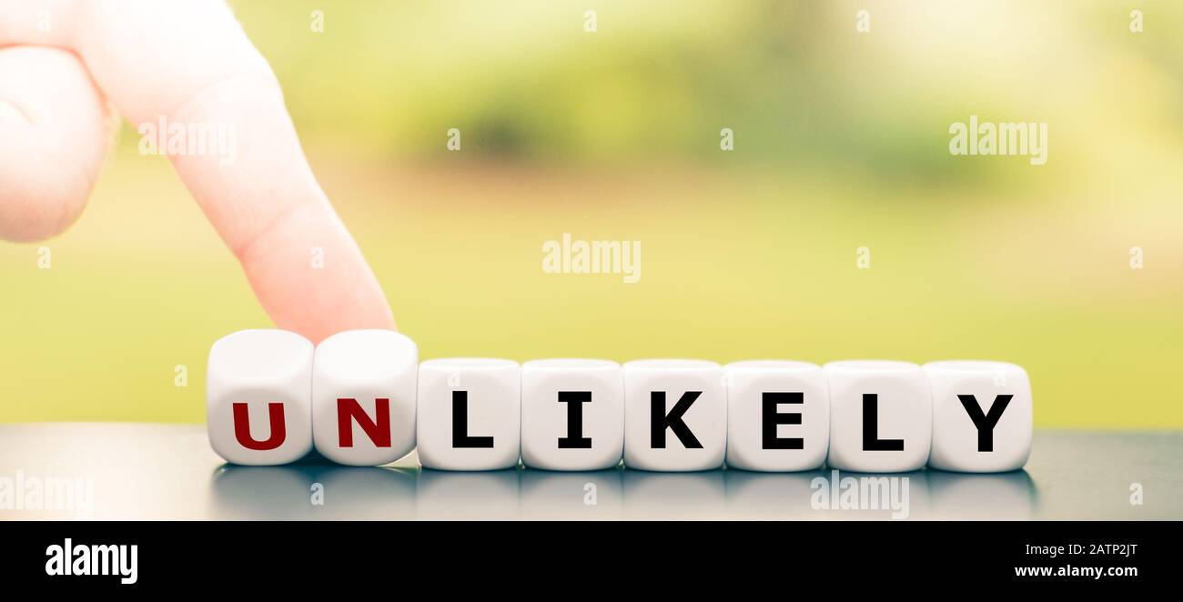 Hand turns dice and changes the word "unlikely" to "likely Stock Photo ...