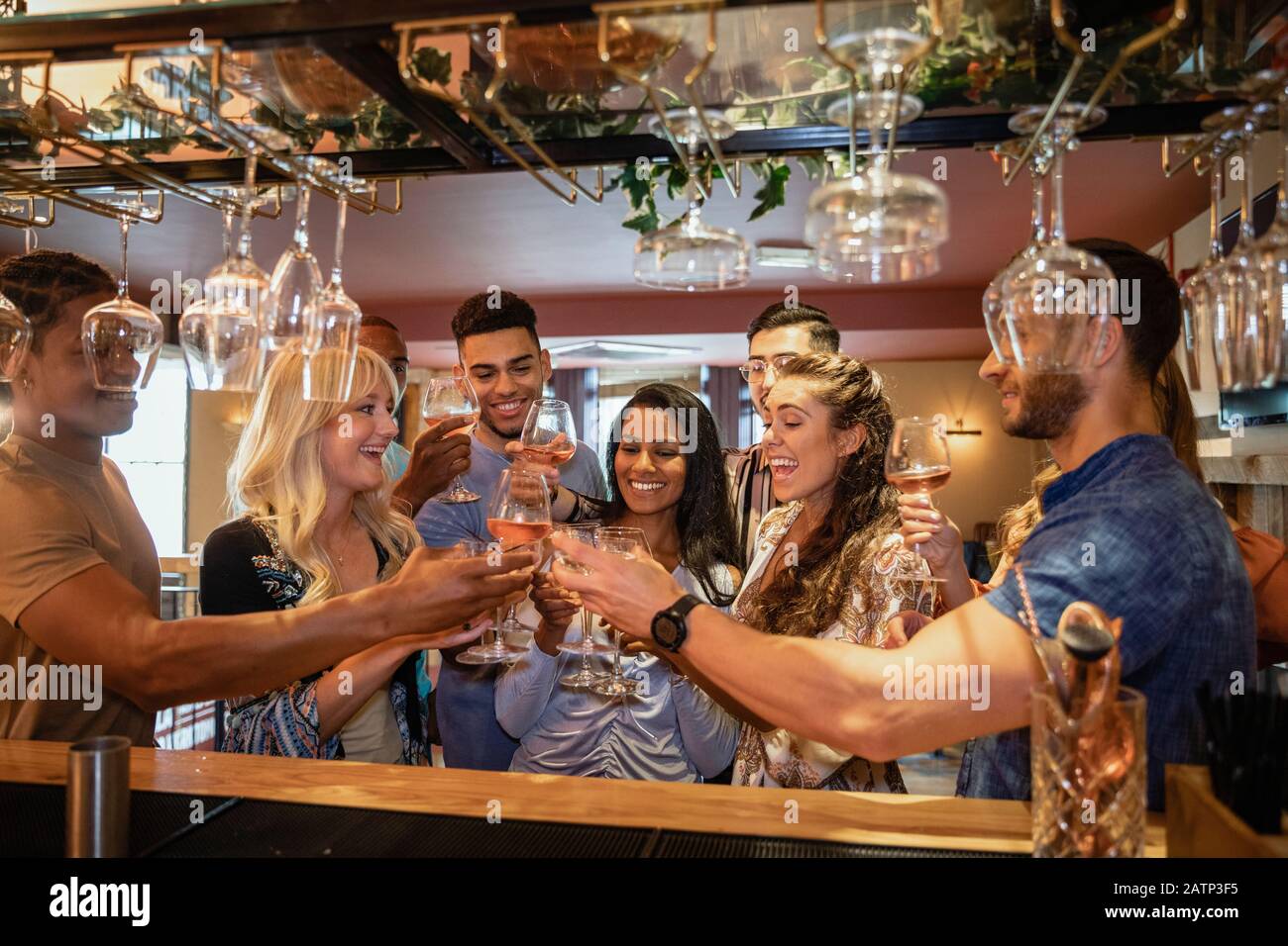 A group of friends having a celebratory toast together in a bar Stock ...