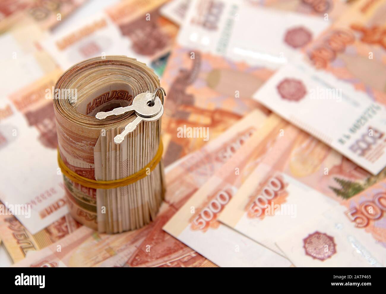 A metal key on a pile of five-thousand-ruble notes Stock Photo - Alamy