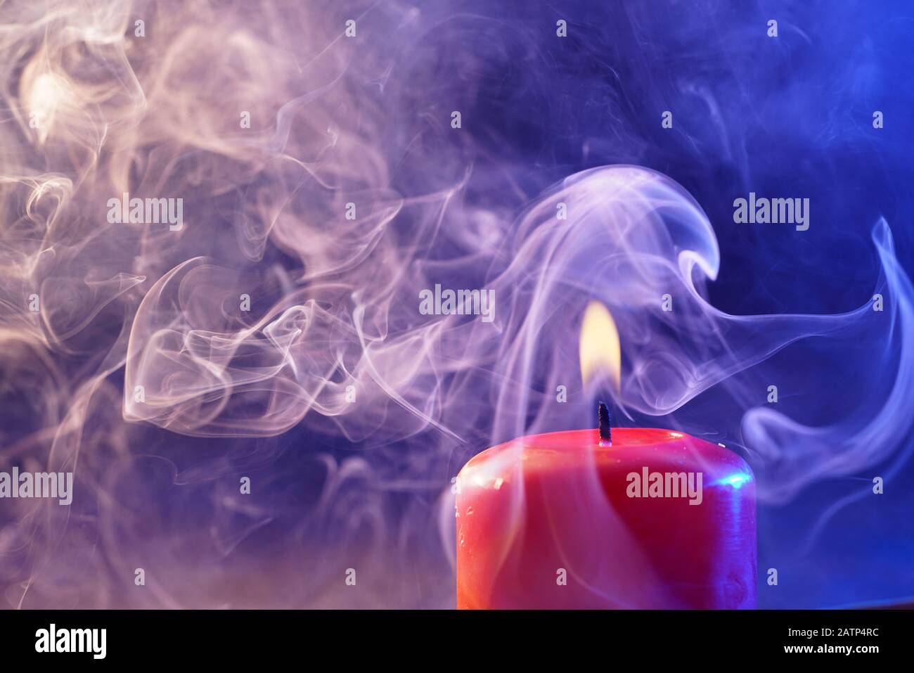 Red candle with smoke and flame photographed in the studio with color ...