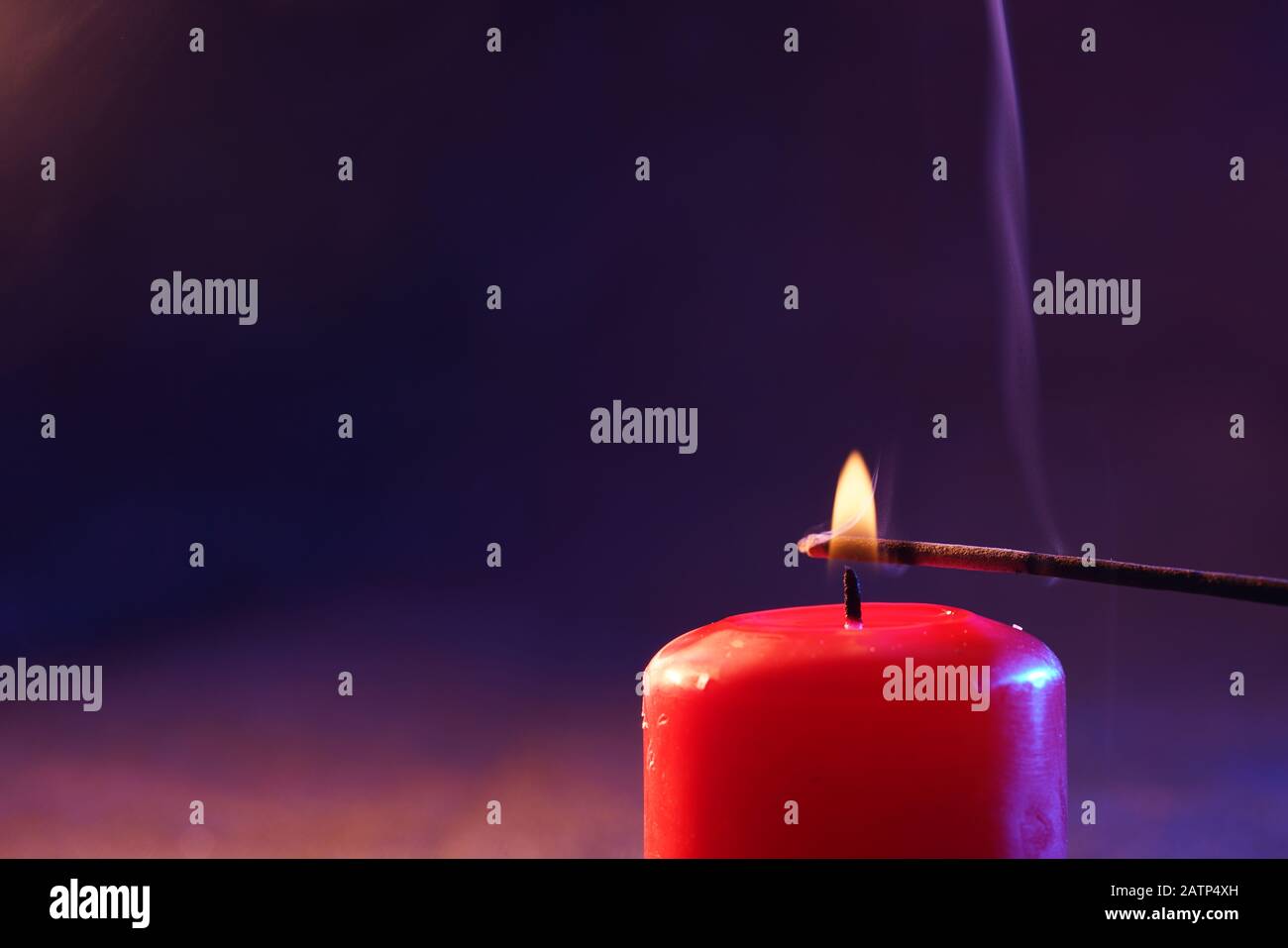 Red candle with smoke and flame photographed in the studio with color ...