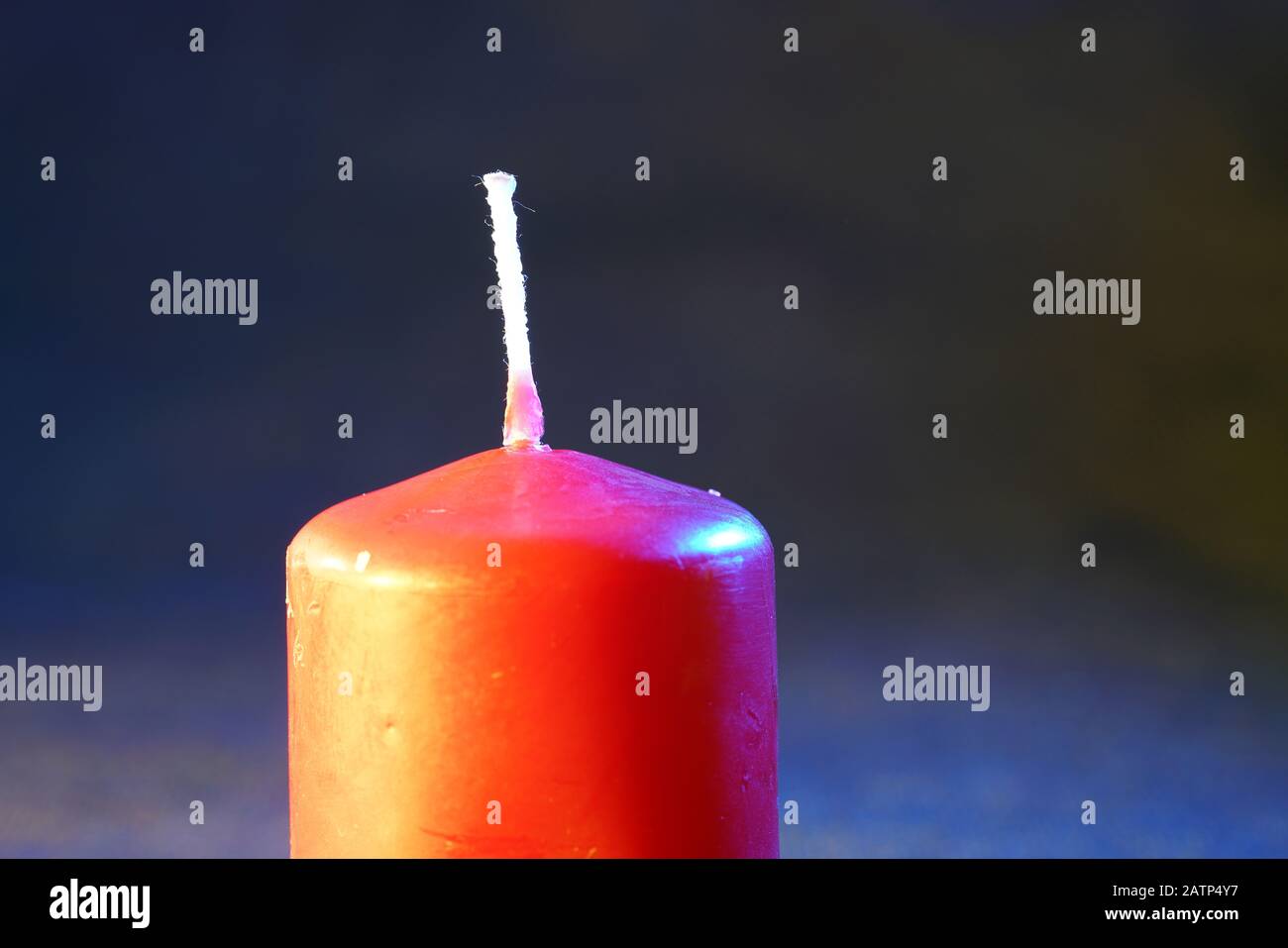 Red candle with smoke and flame photographed in the studio with color ...