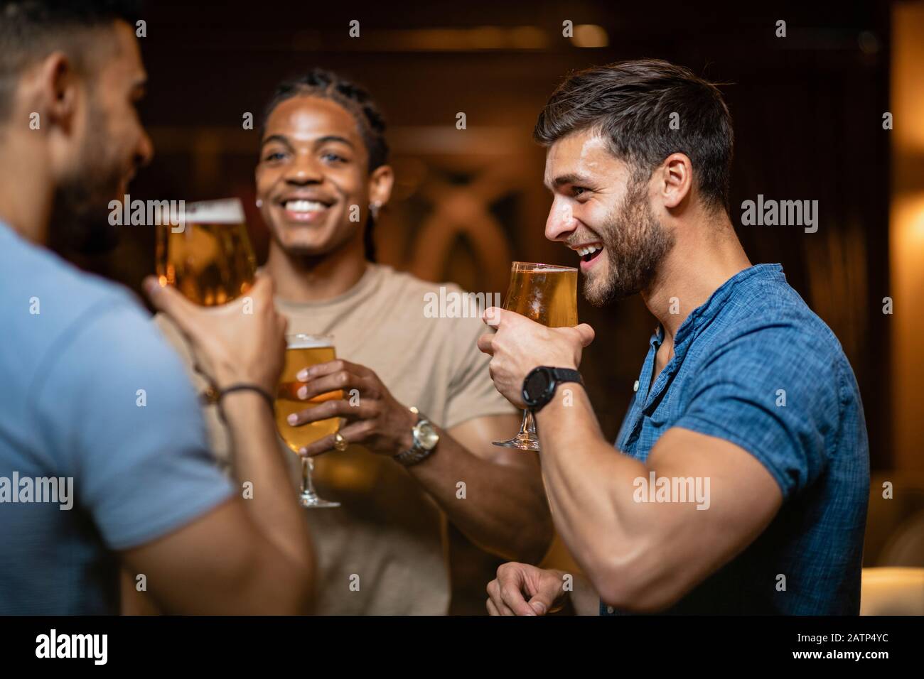 A group of male friends having a pint of beer together in a bar Stock ...