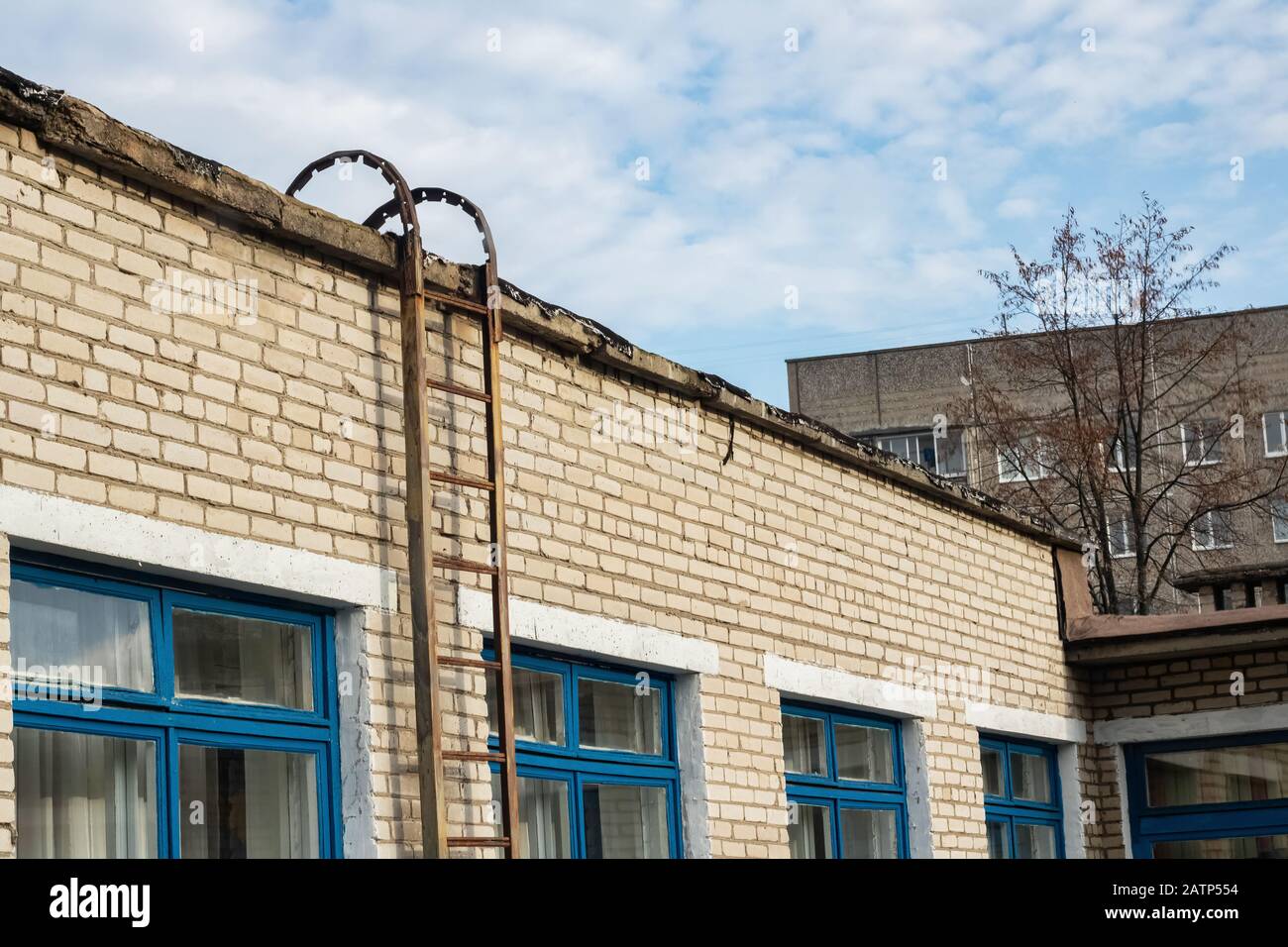 Blue windows of brick building and staircase to roof Stock Photo - Alamy
