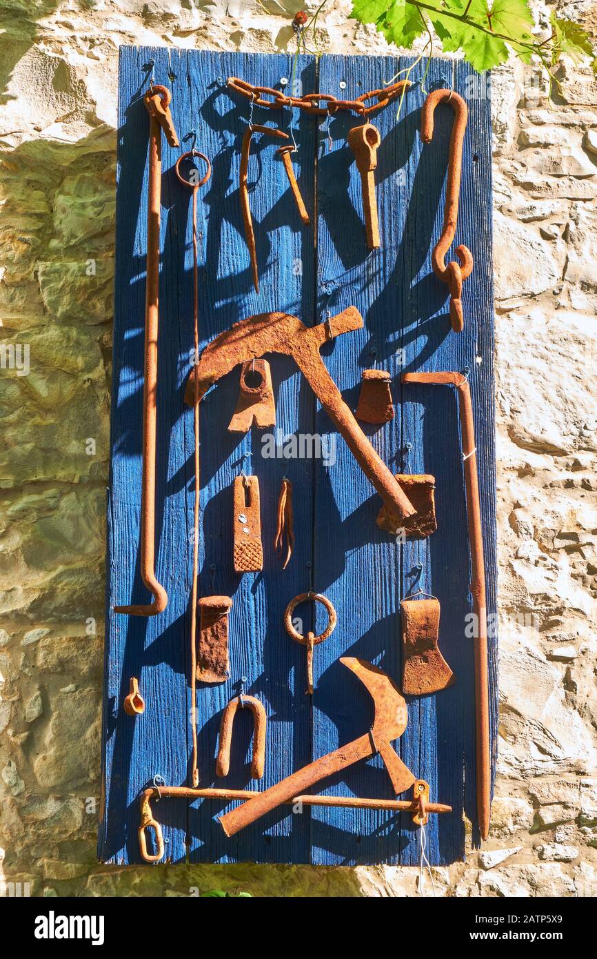 Decorative composition of building hand-held vintage tools on the house ...