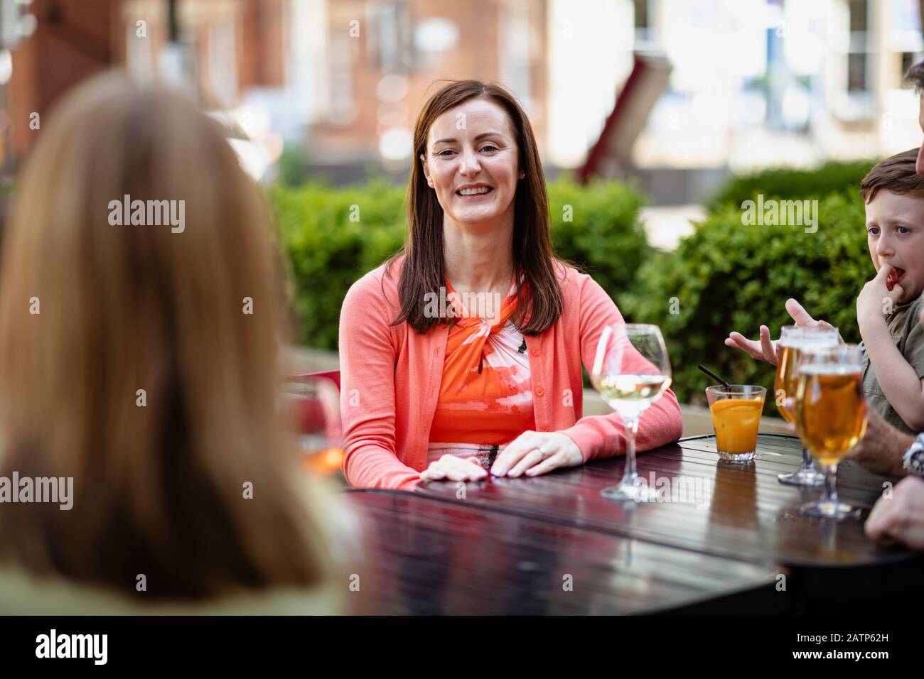 A family having drinks together outdoors at a bar Stock Photo - Alamy