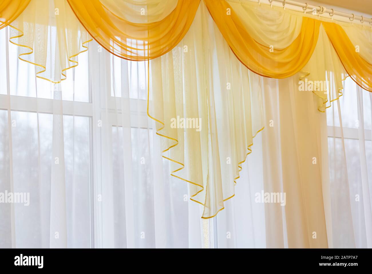 Delicate yellow tulle on the window, room decor Stock Photo - Alamy