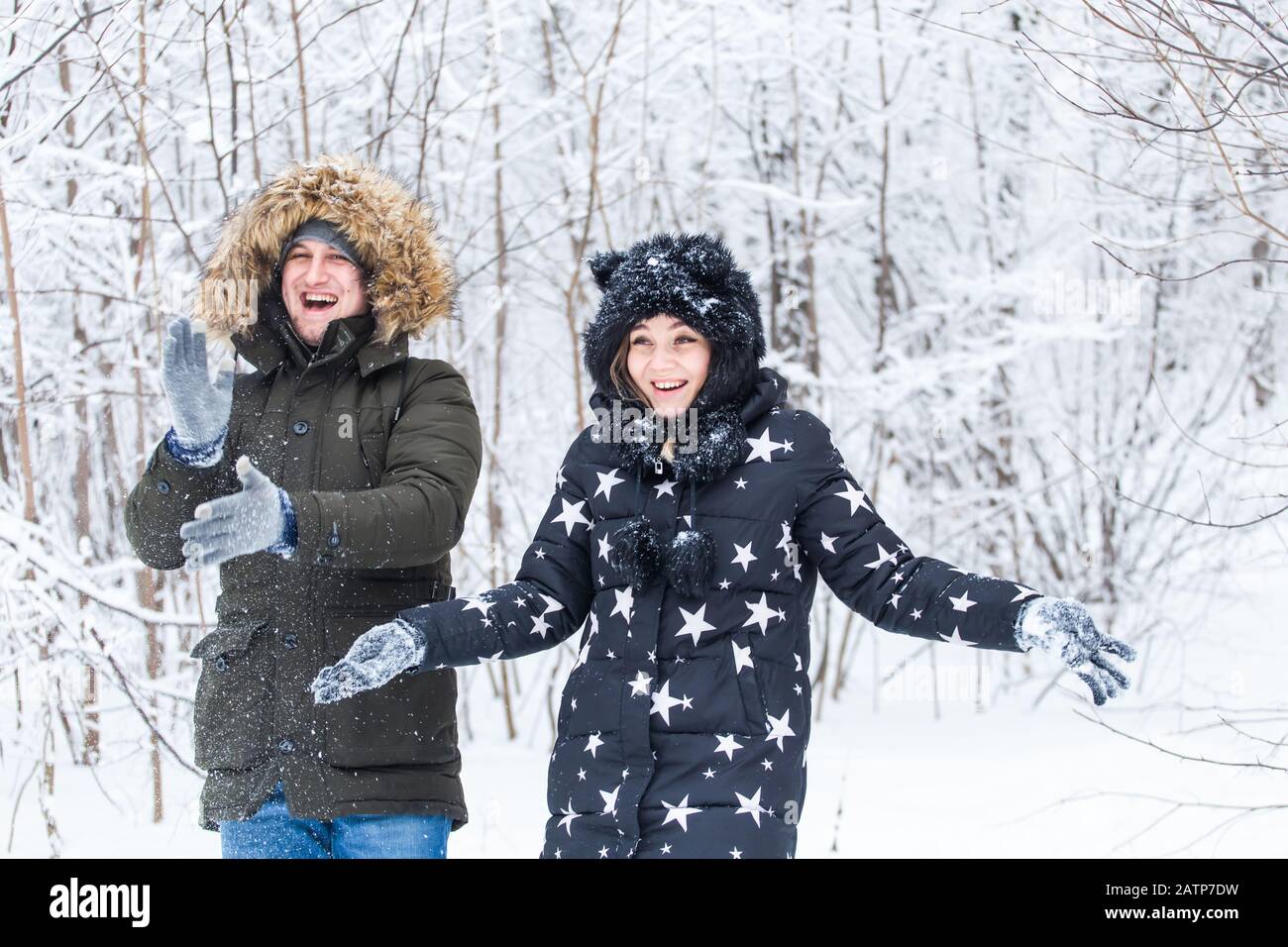 Young couple playing with snow in winter park Stock Photo - Alamy