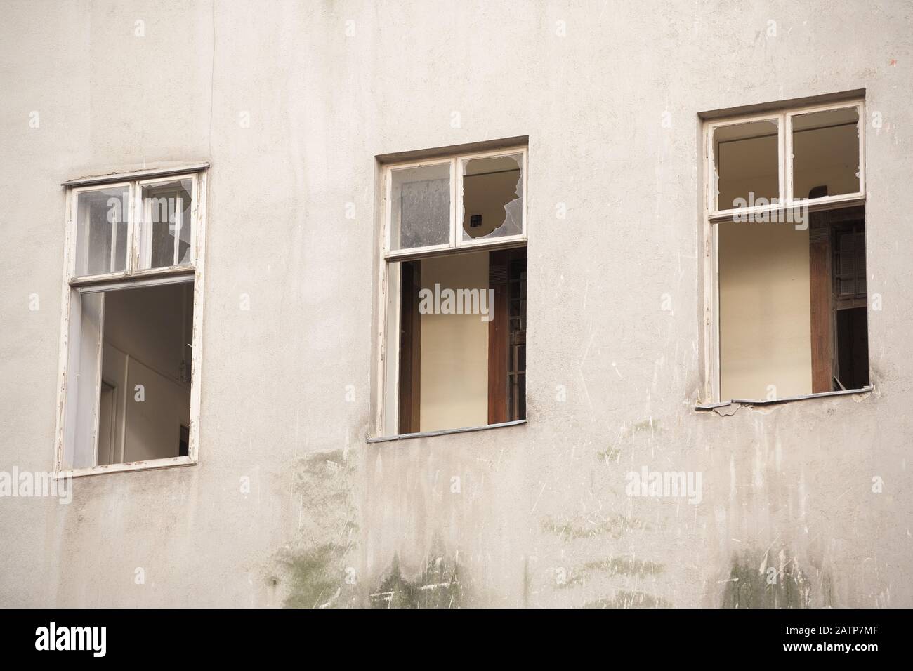Three broken windows of an old abandoned house. Demolition, renovation ...