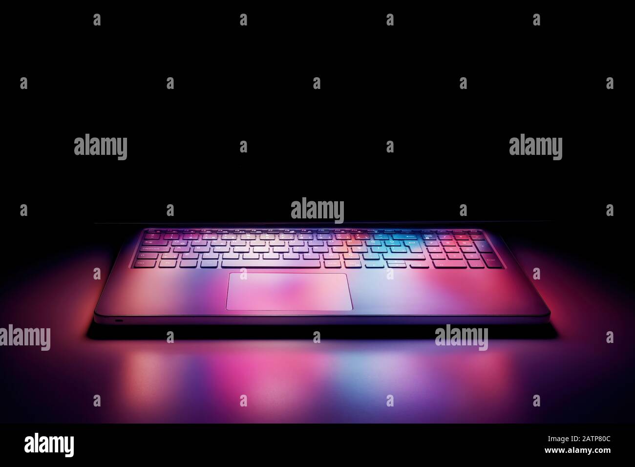 Half open laptop computer screen reflecting colorful lights on the ...
