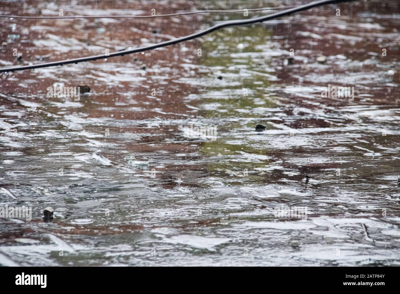 Close up raindrops falling puddle hi-res stock photography and images ...