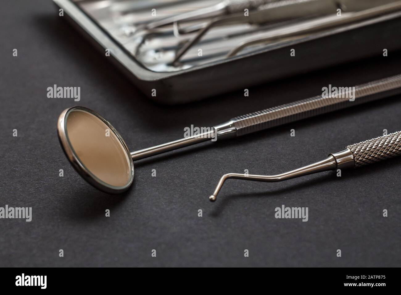 Set of metal dental instruments for dental treatment. Medical tools in ...