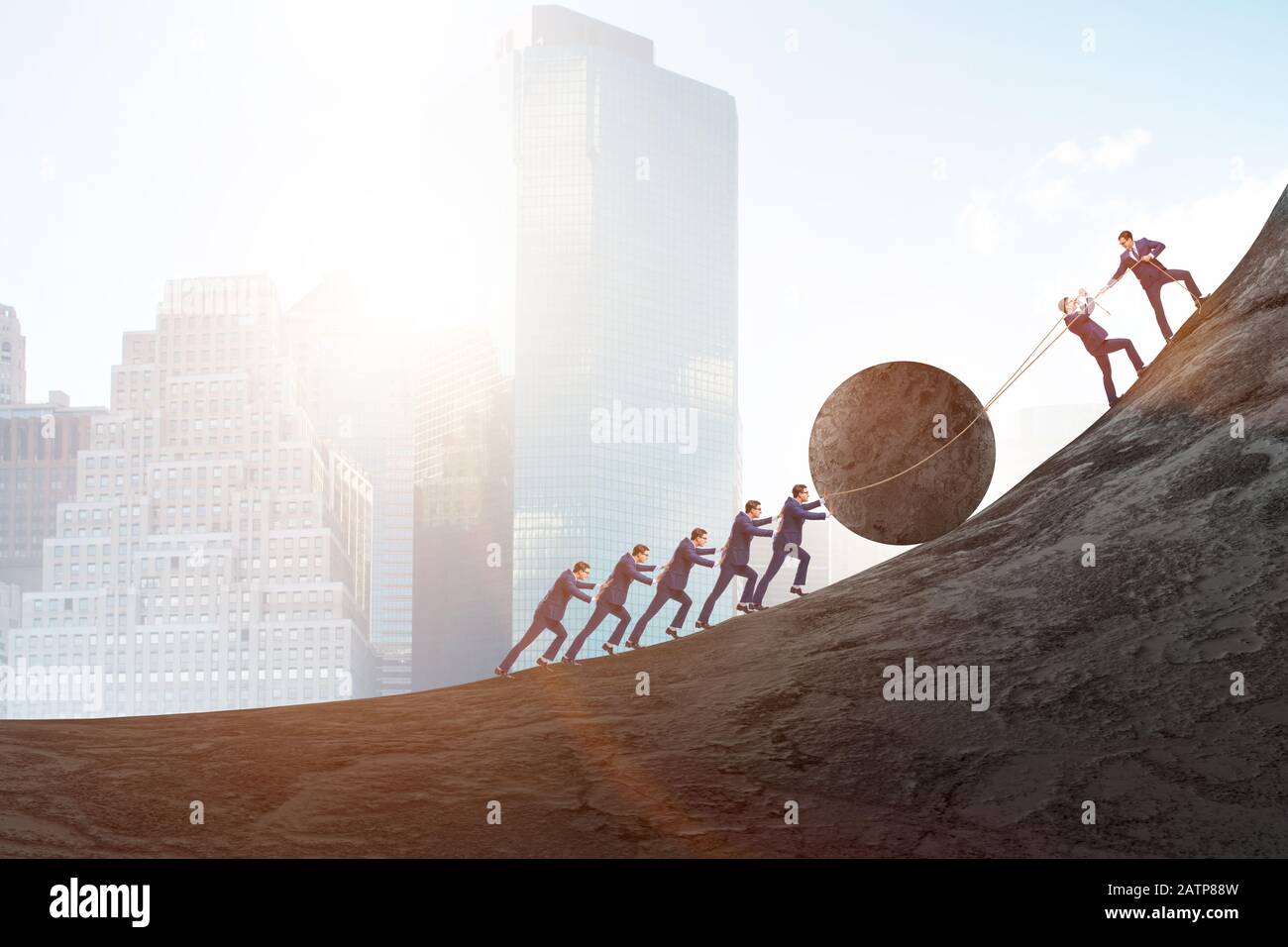 The teamwork example with business people pushing stone to top Stock ...