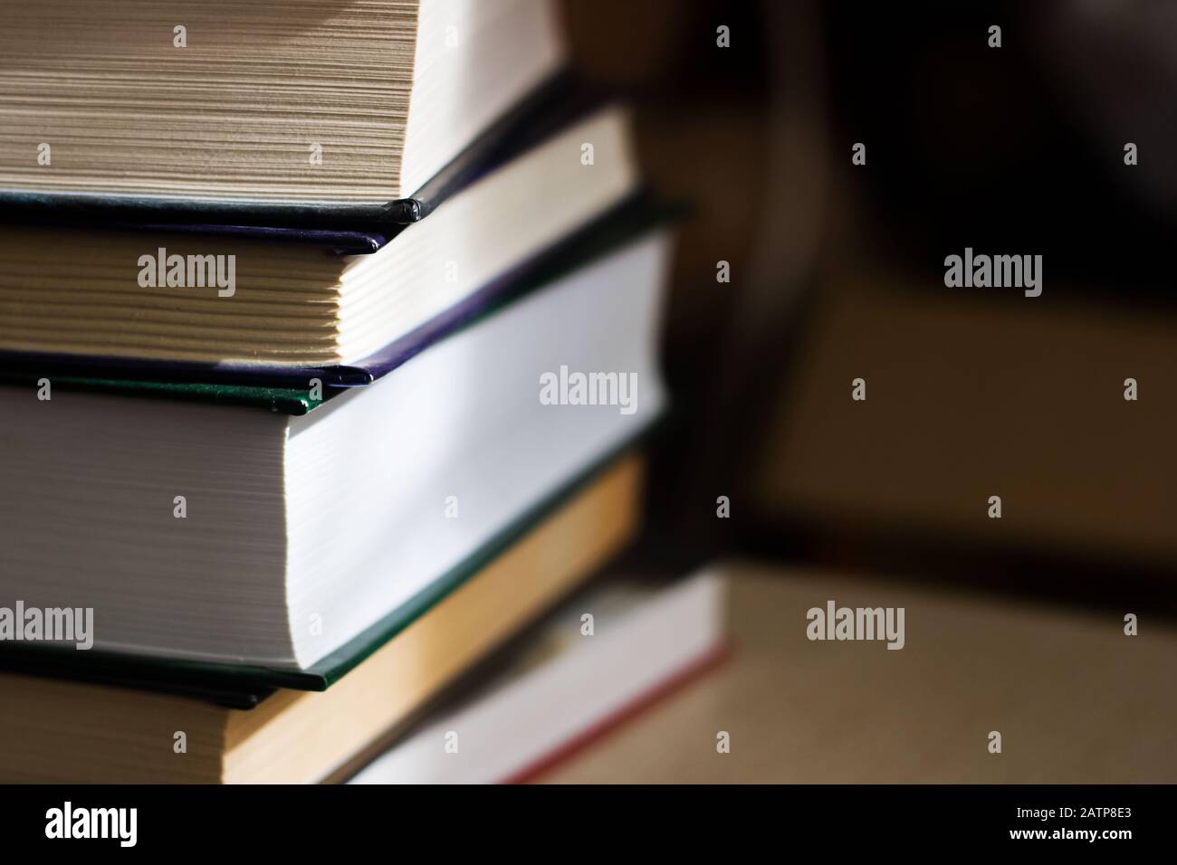 Stack of books close up in the dark Stock Photo - Alamy