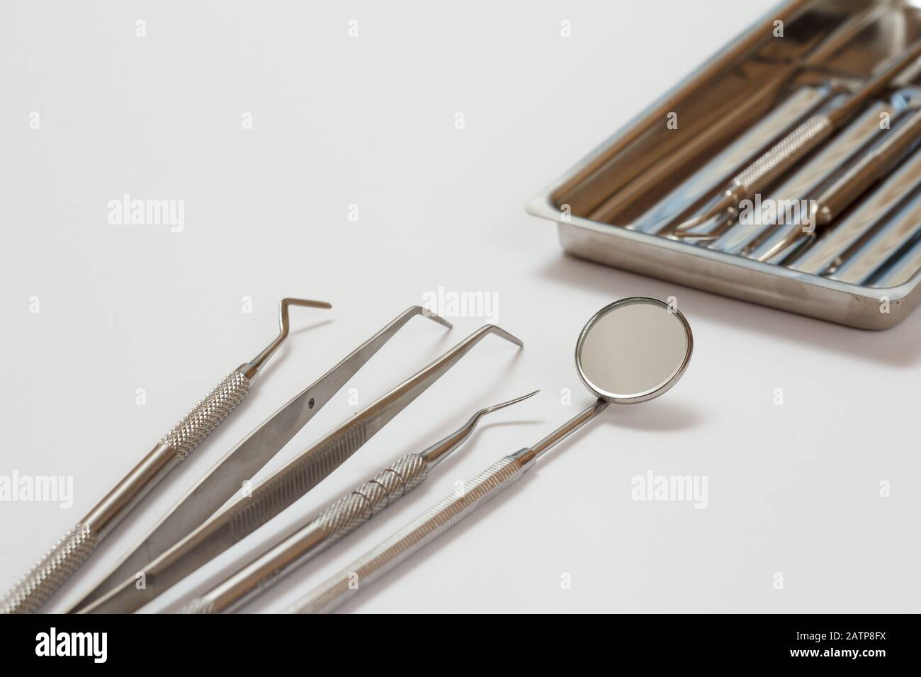 Set of metal dental instruments for dental treatment on white ...