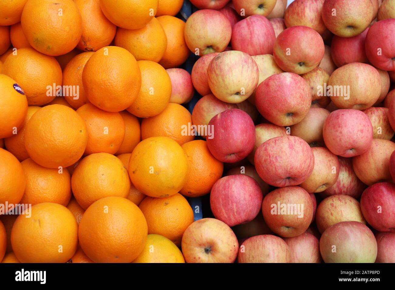 Orange and red apple in the shop Stock Photo - Alamy