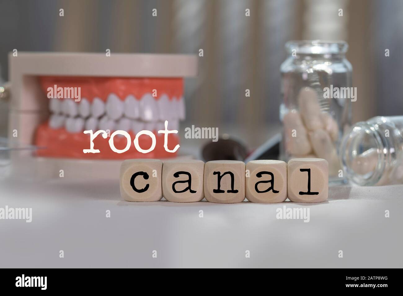 Words ROOT CANAL composed of wooden dices. Pills, documents, pen, human ...