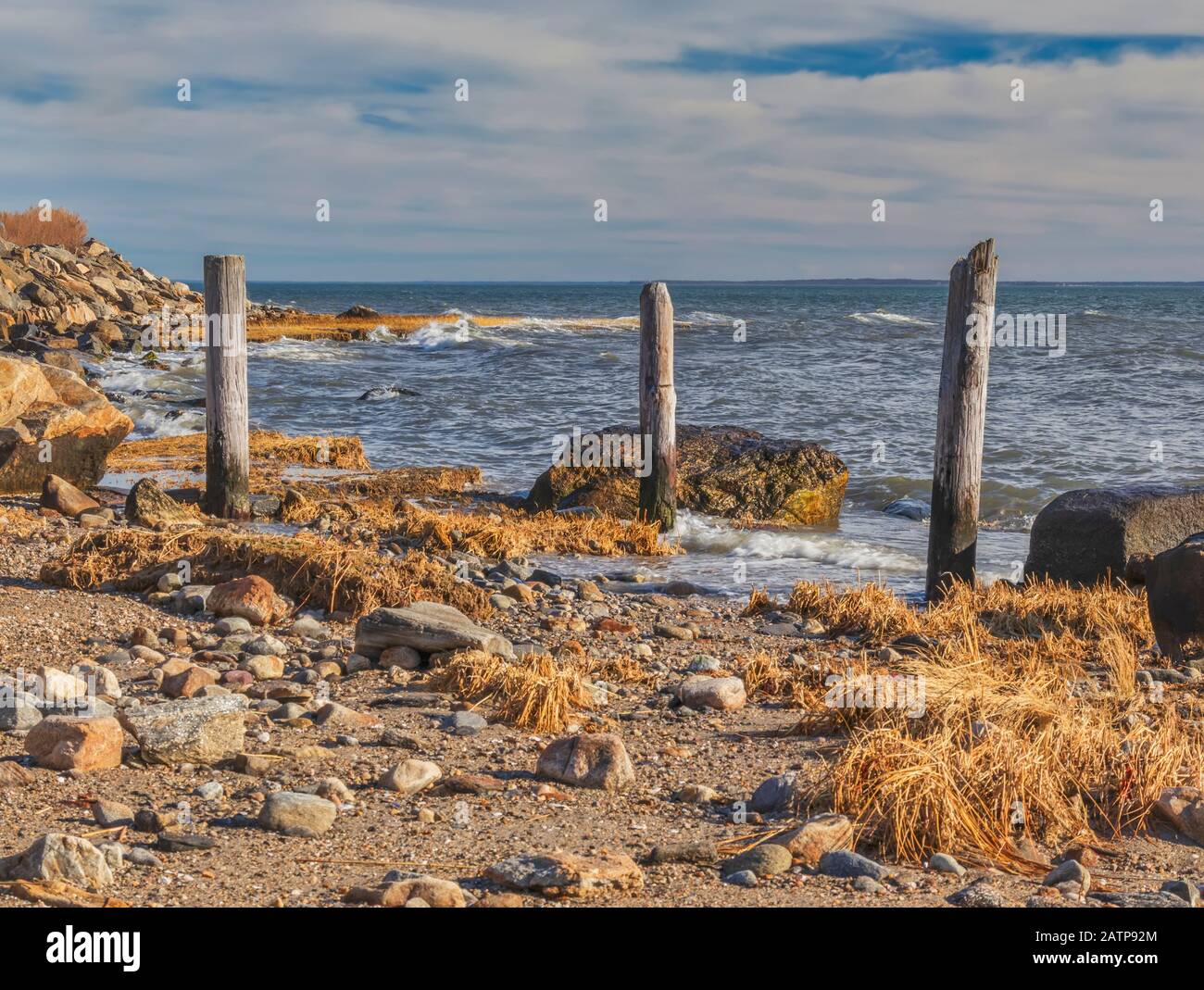 Three pier posts oceanfront Stock Photo - Alamy