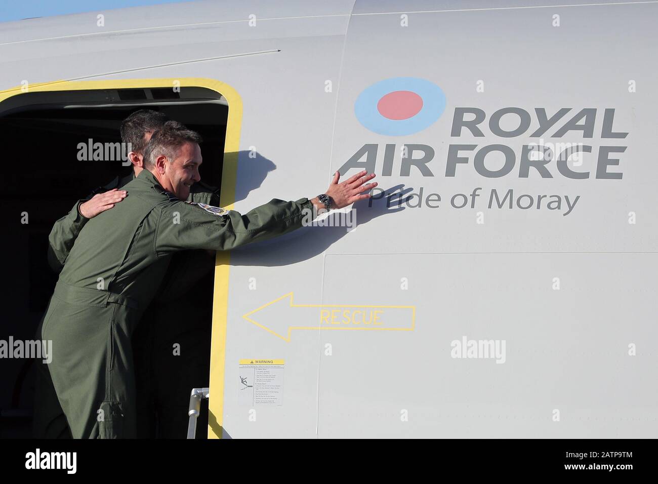 Squadron Leader Mark Faulds reaches out to touch the plane's names at ...