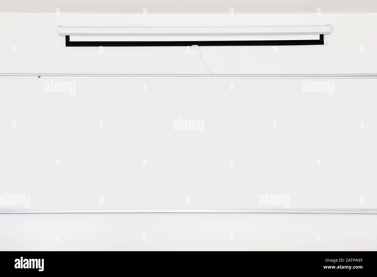 White board and a folding projection screen on the classroom wall ...