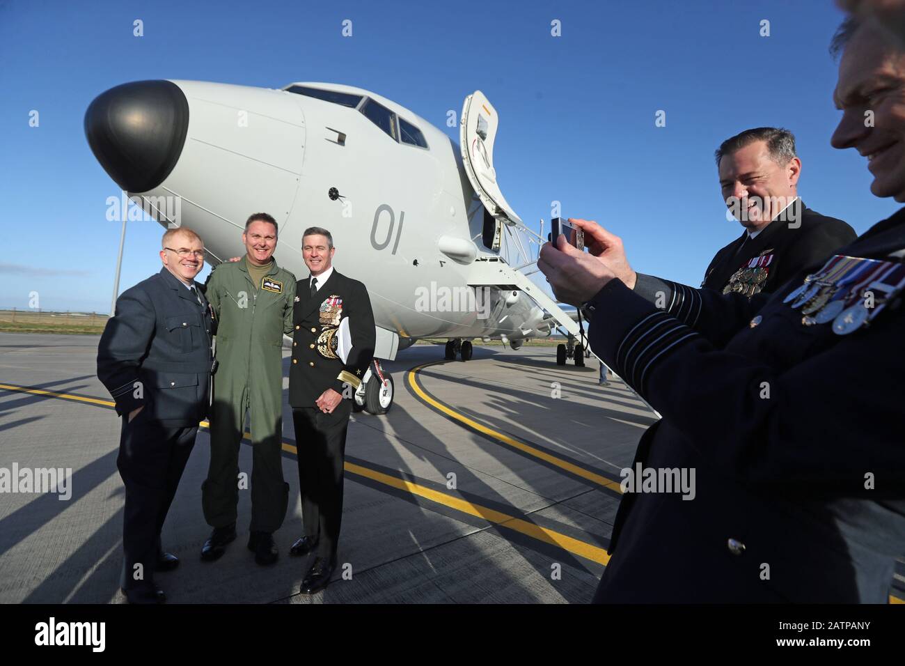 Squadron Leader Mark Faulds (second left) poses for a photograph at ...