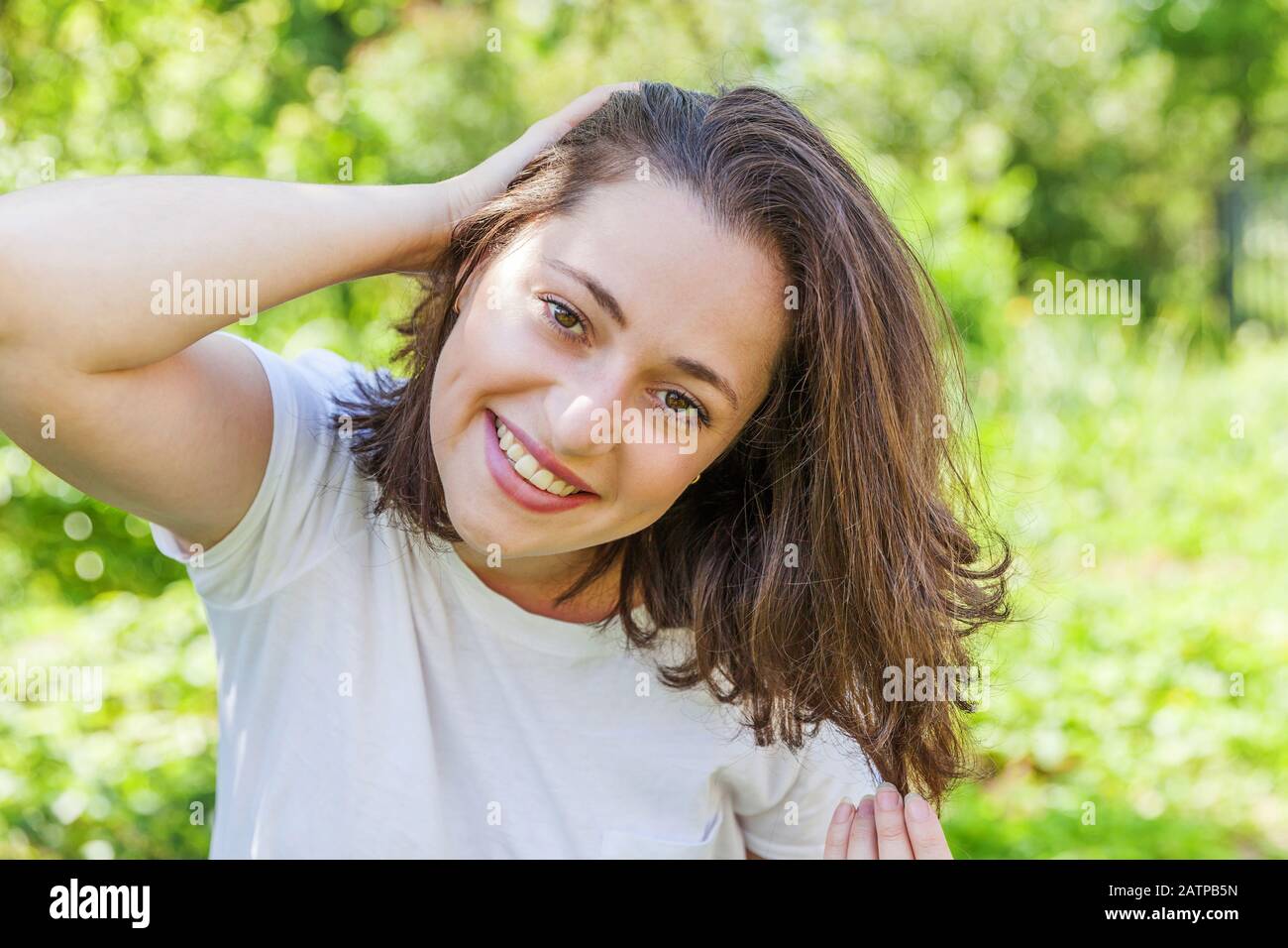 Happy girl smiling outdoor. Beautiful young brunete woman with brown ...