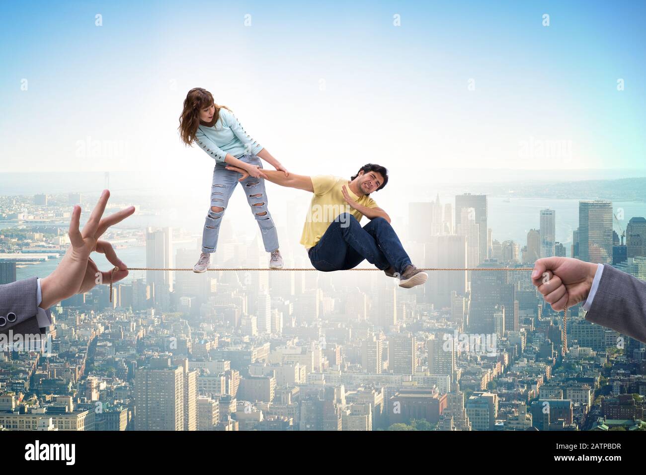 The young family on tight rope Stock Photo - Alamy