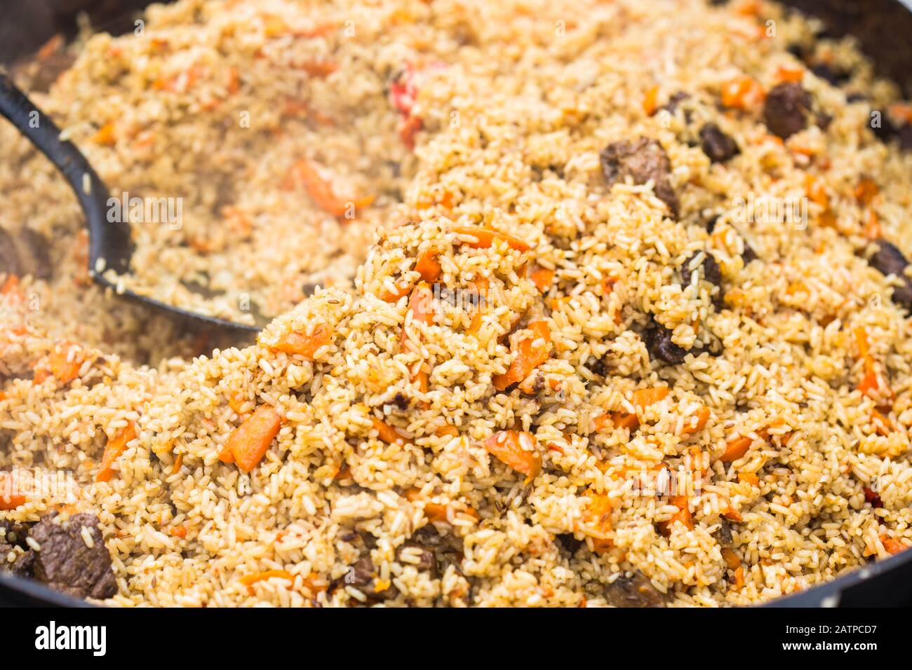 Street food festival concept - food pilaf in a cauldron close up Stock ...