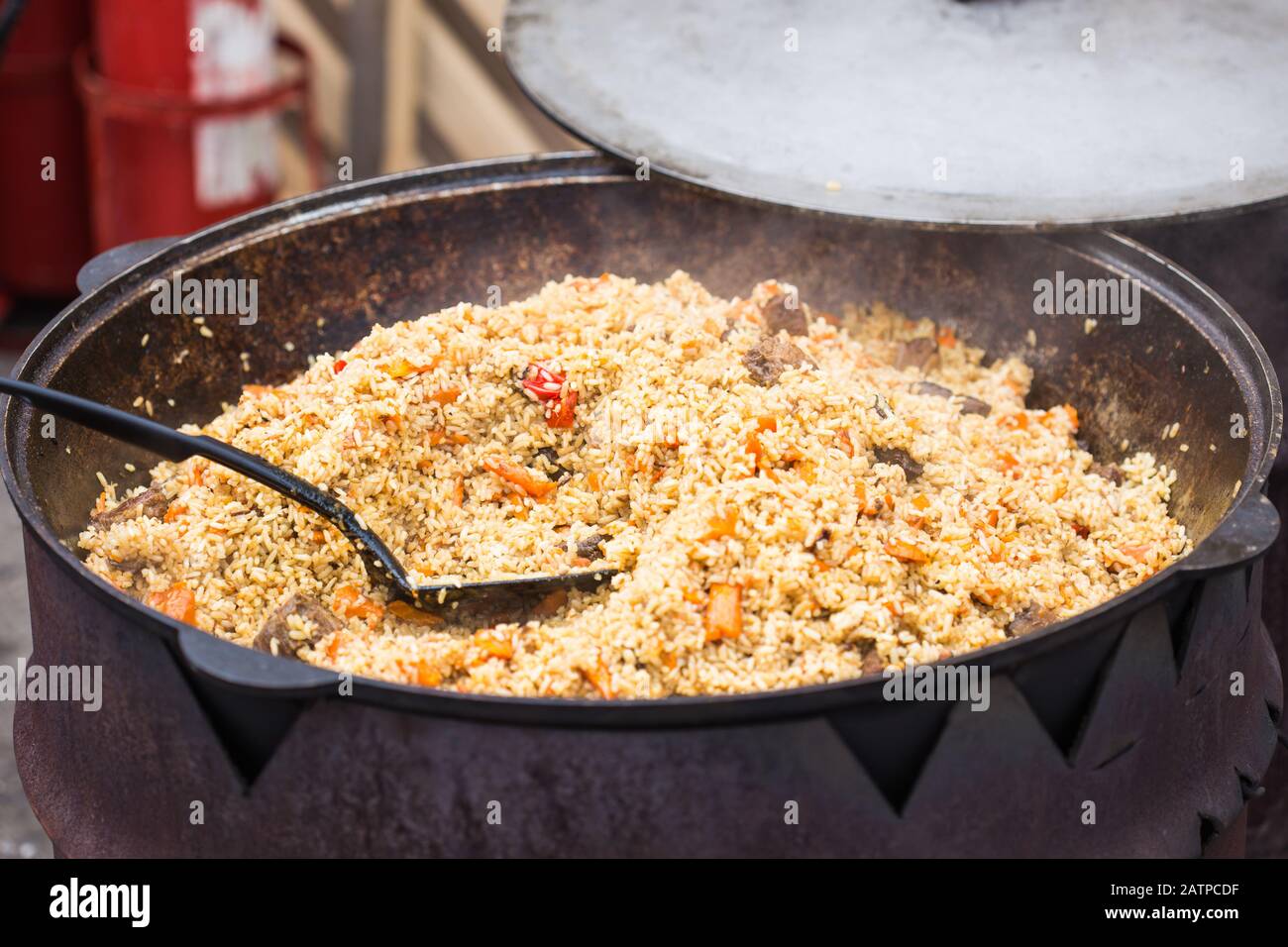Street food festival concept - food pilaf in a cauldron close up Stock ...