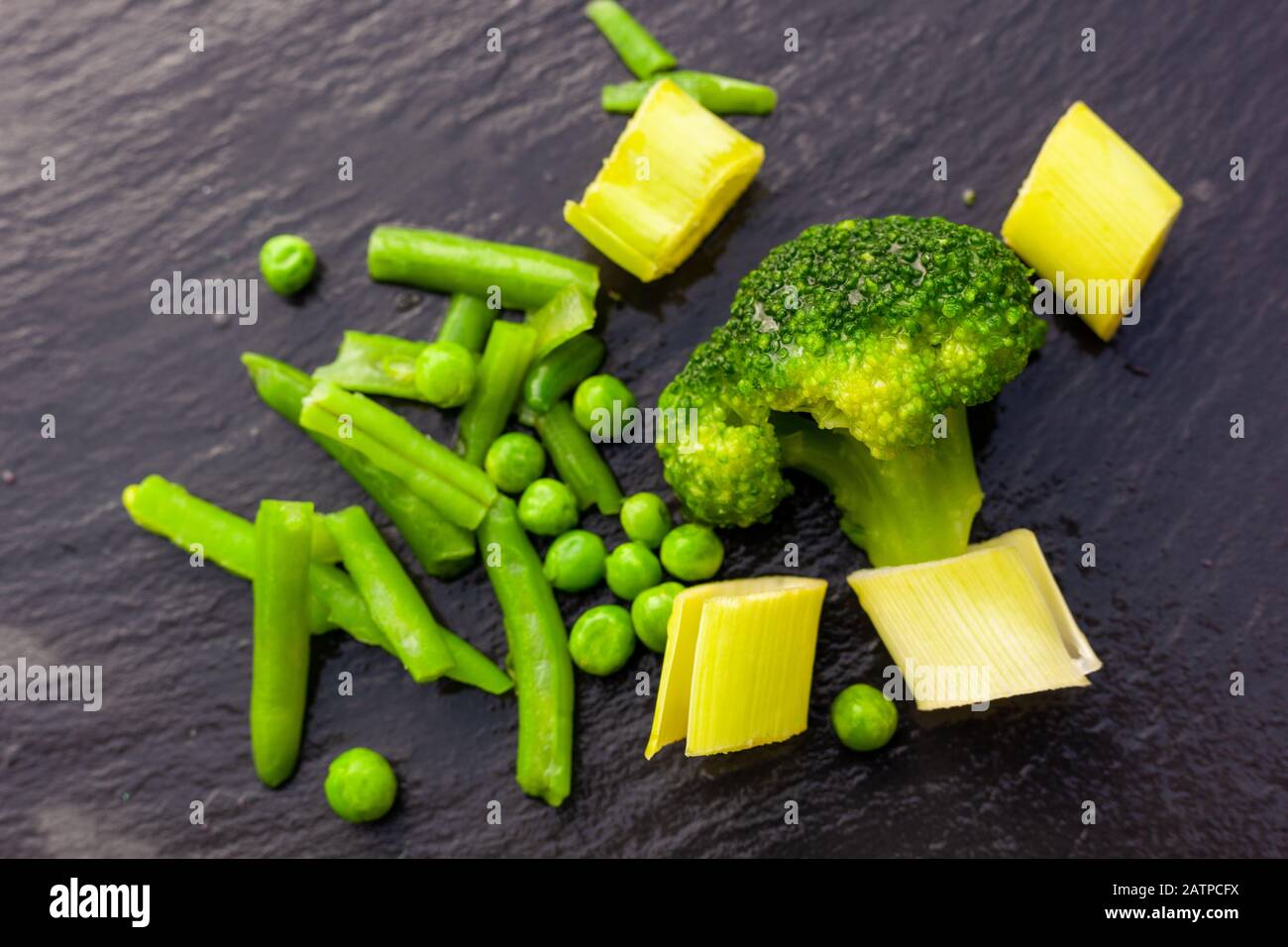 Healthy foods - Broccoli, Peas, Sliced Greens & chopped Leeks on a ...