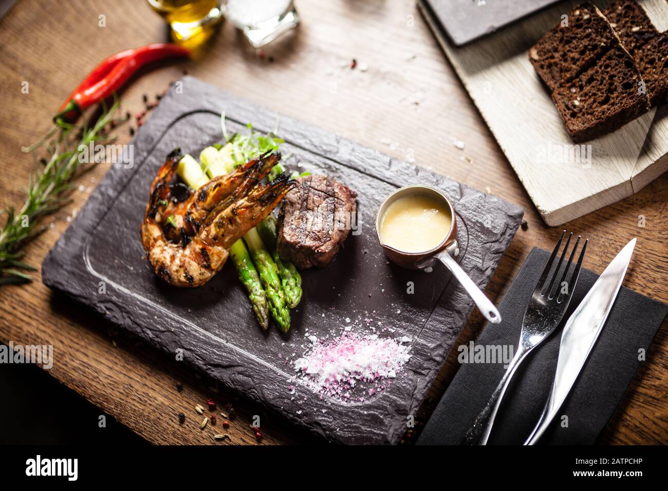 Tasting menu. Beef steak and grilled tiger prawns Stock Photo - Alamy