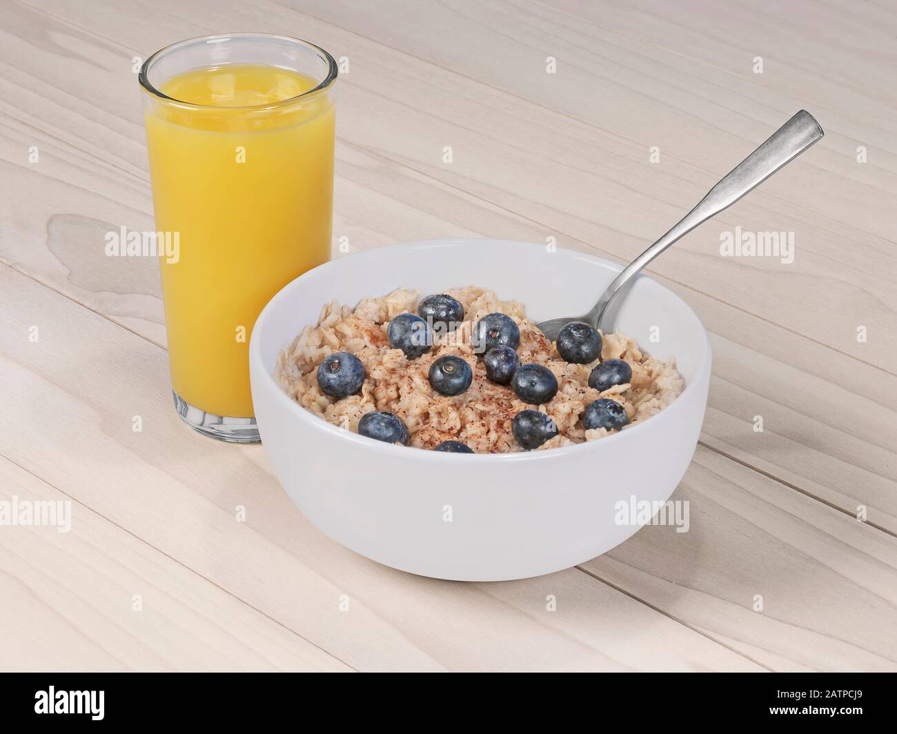 Oatmeal with blueberries and glass of orange juice Stock Photo - Alamy