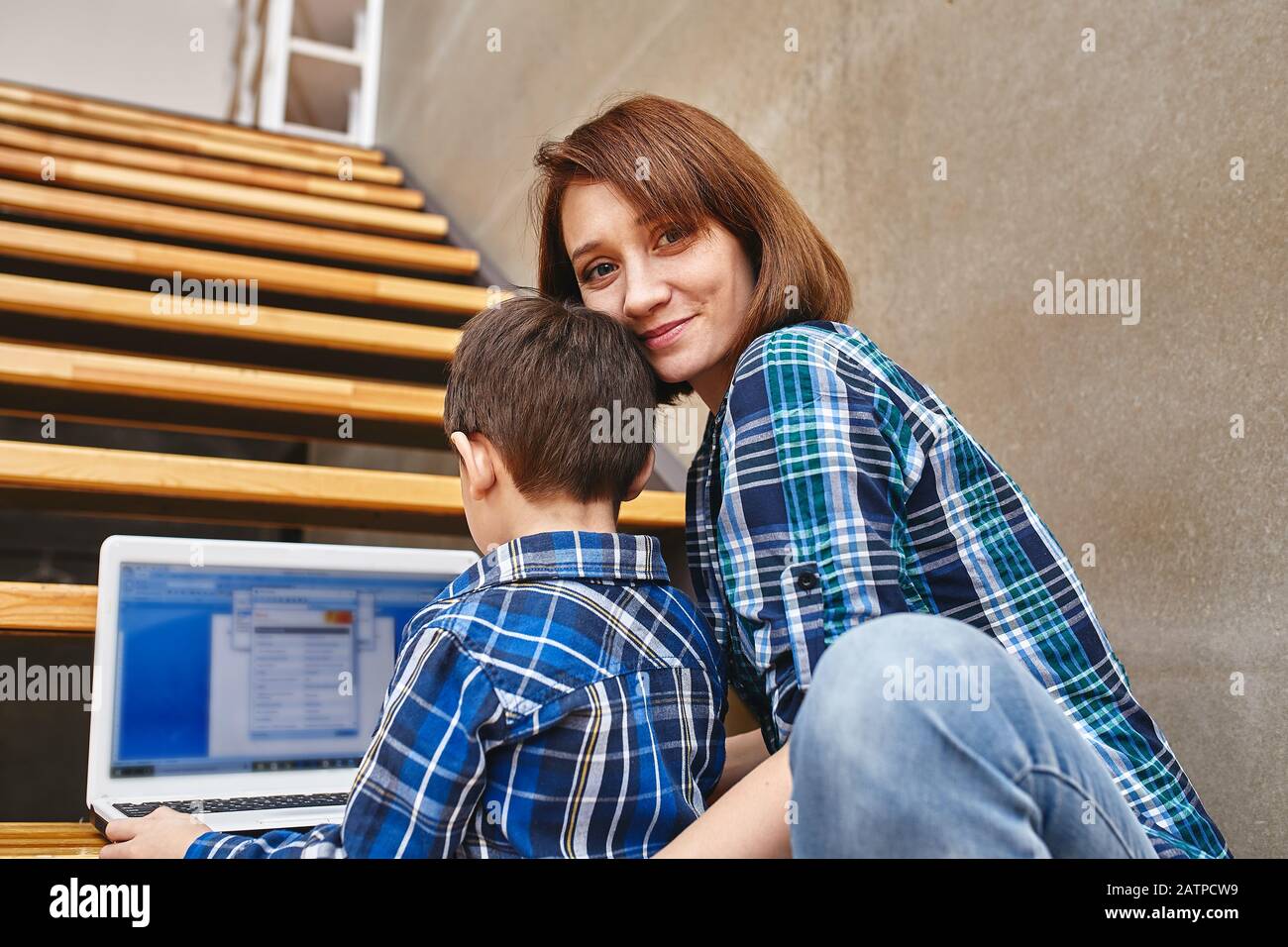 Mom and son are doing homework on the computer. Concept mom and ...