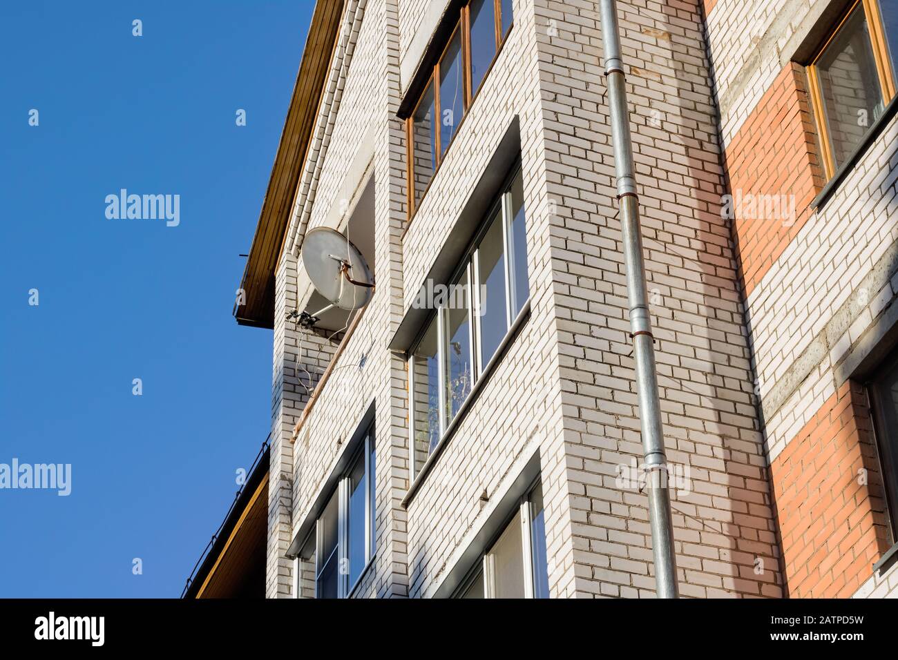 Windows of a tall house on a background of blue sky Stock Photo - Alamy