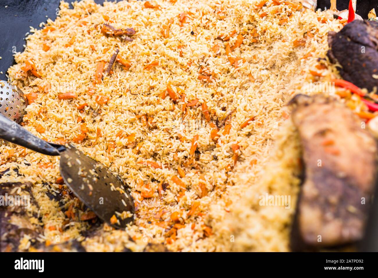 Street food festival concept - food pilaf in a cauldron close up Stock ...